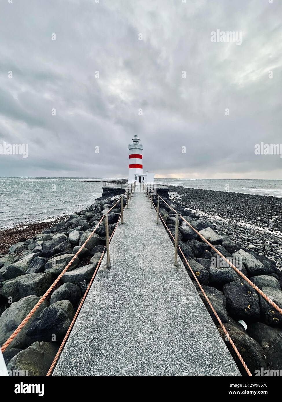 Image depicting the end of a walkway extending into the sea, where a ...