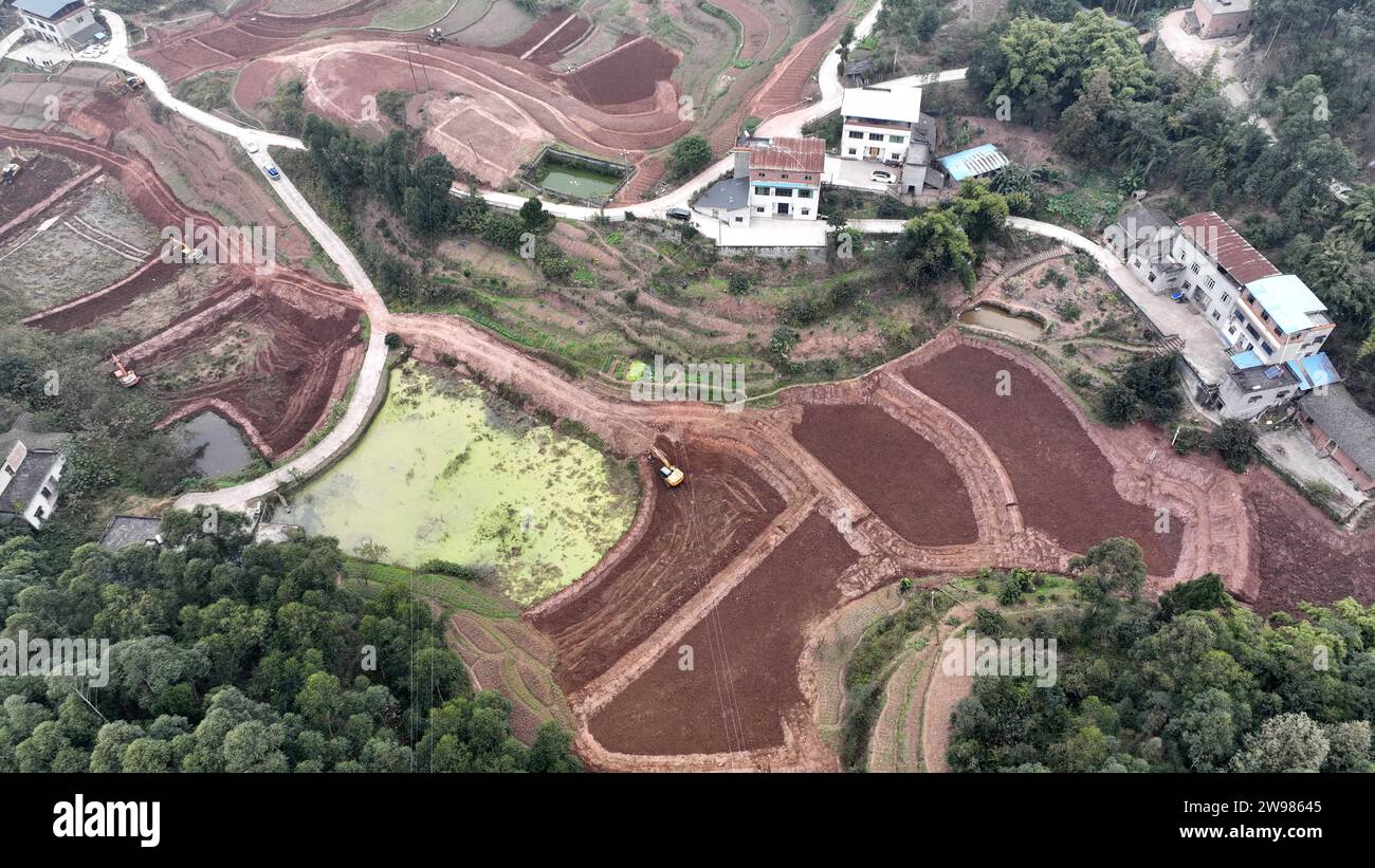 CHONGQING, CHINA - DECEMBER 25, 2023 - An excavator flattens the land ...