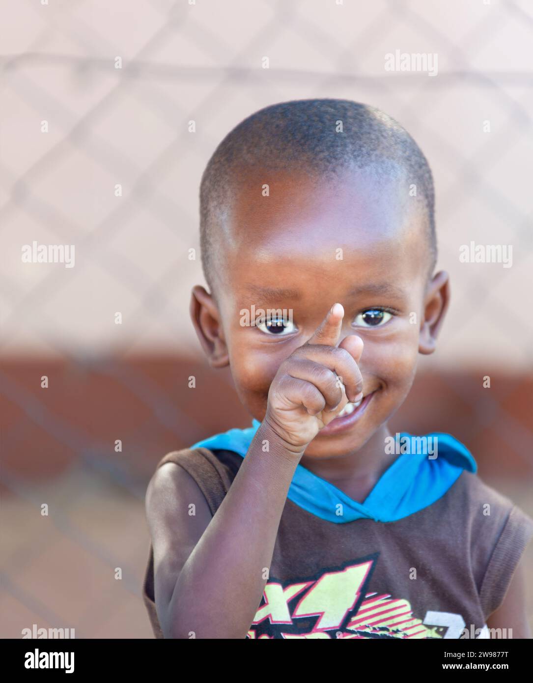 african village, happy african child pointing finger and being cheeky ...