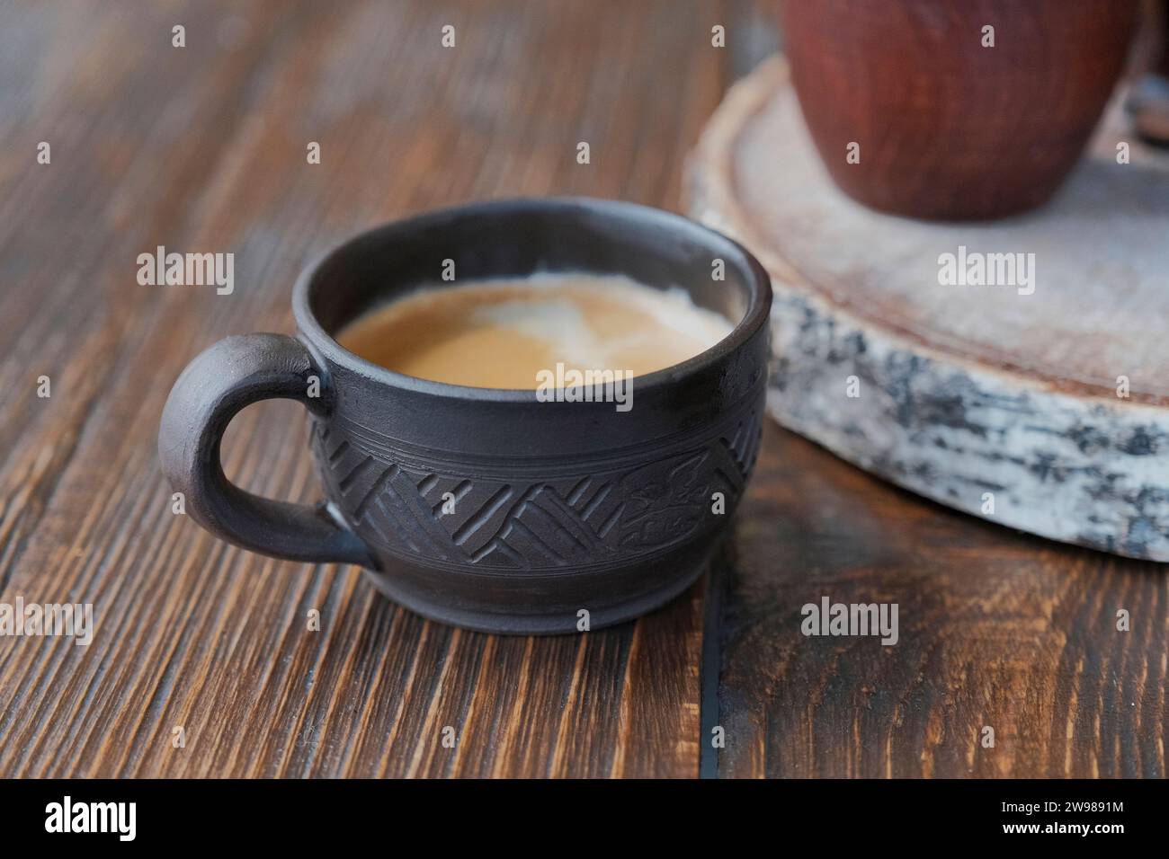 Clay cup with black coffee Stock Photo - Alamy