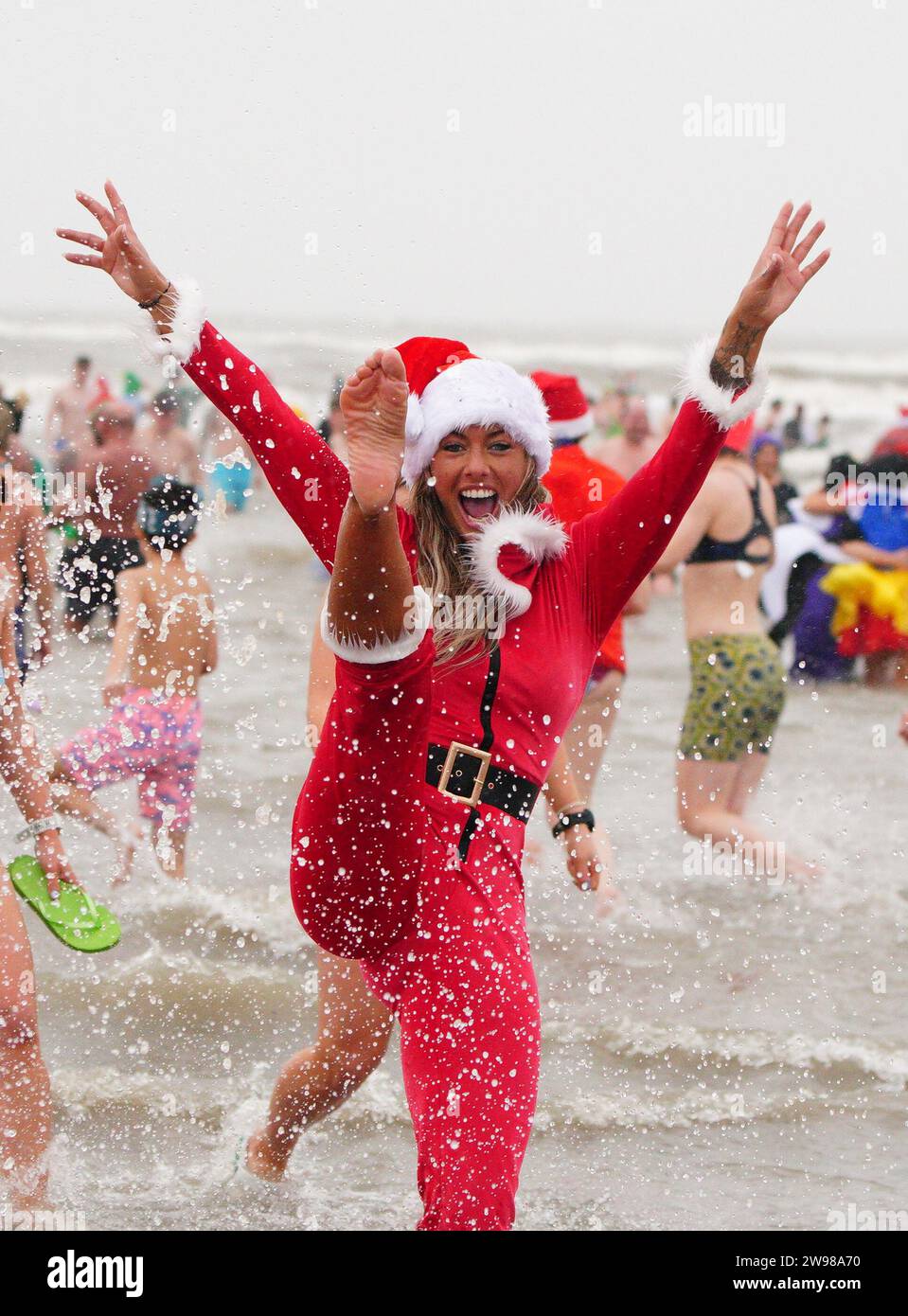Swimmers take part in the Christmas Day swim in Porthcawl, Wales ...