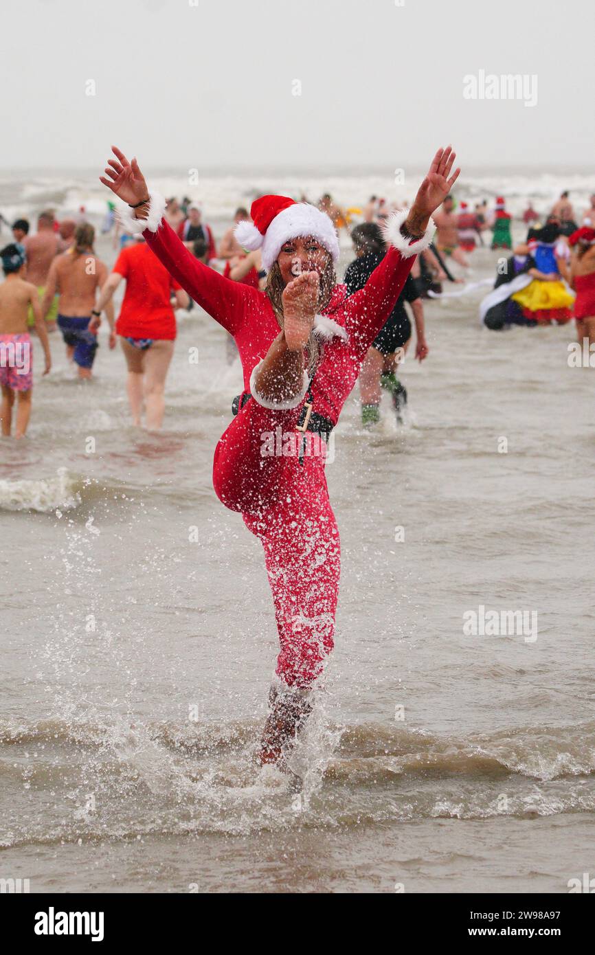 Swimmers take part in the Christmas Day swim in Porthcawl, Wales ...
