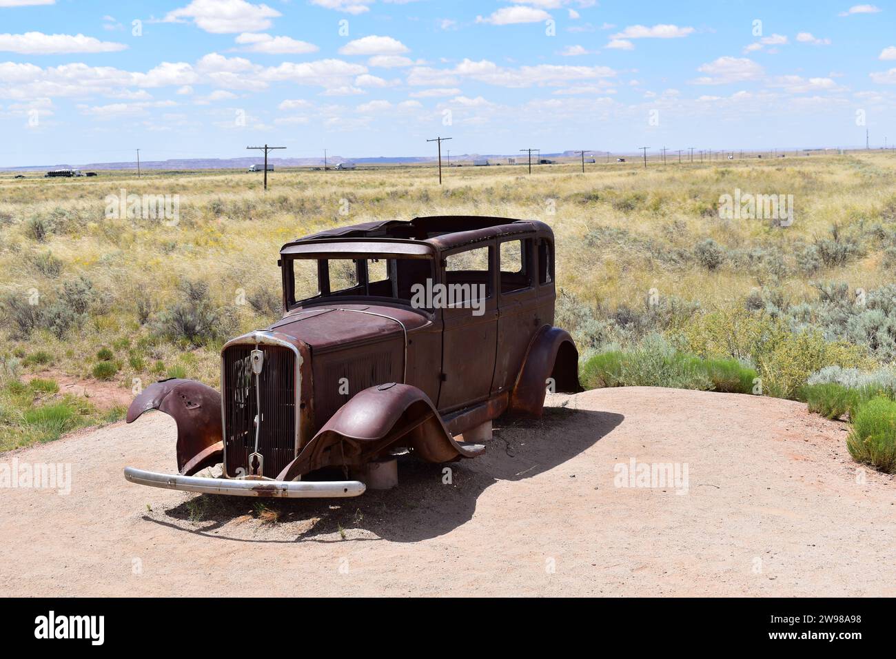 The rusted metal body of a 1932 Studebaker automobile resting near the ...