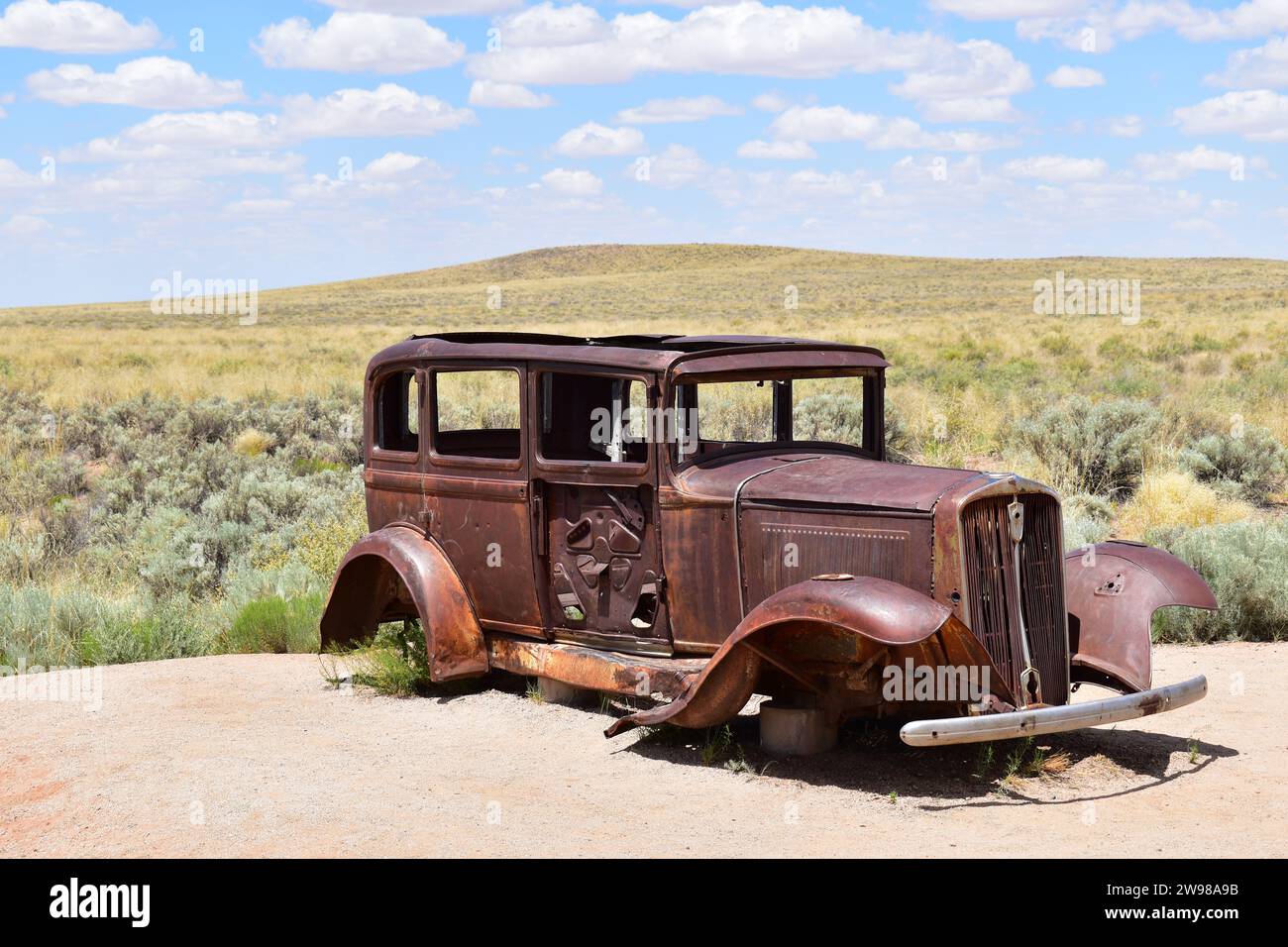 The rusted metal body of a 1932 Studebaker automobile resting near the ...