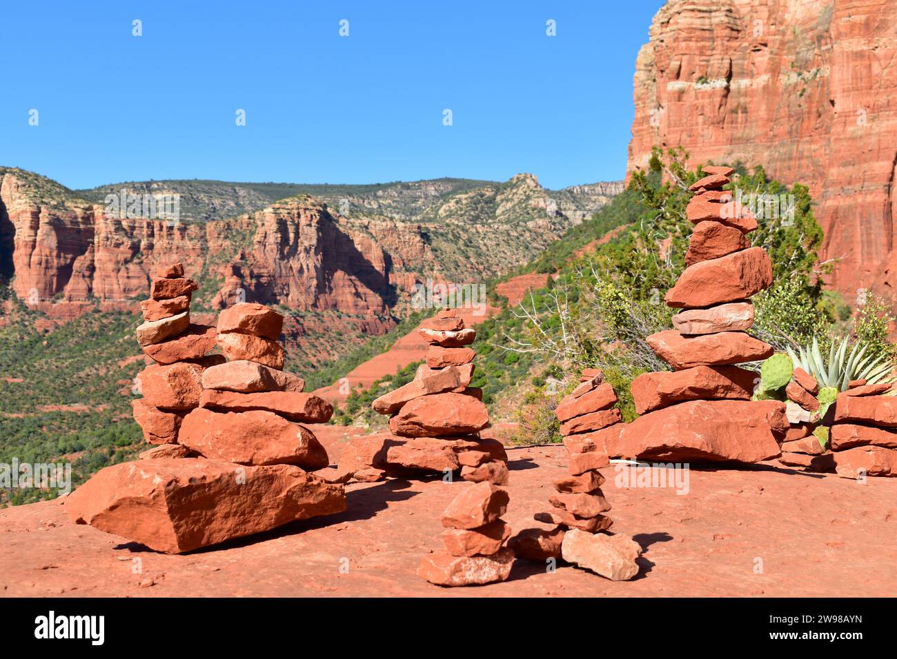 Stone cairns built by hikers on the mountainside of Bell Rock in Sedona ...