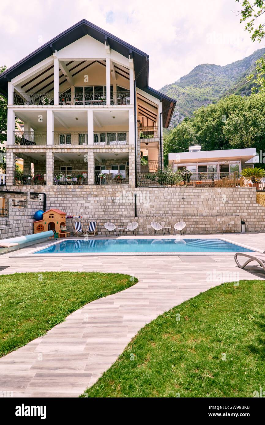 Paved path to the pool near the three-storey villa on the mountainside ...