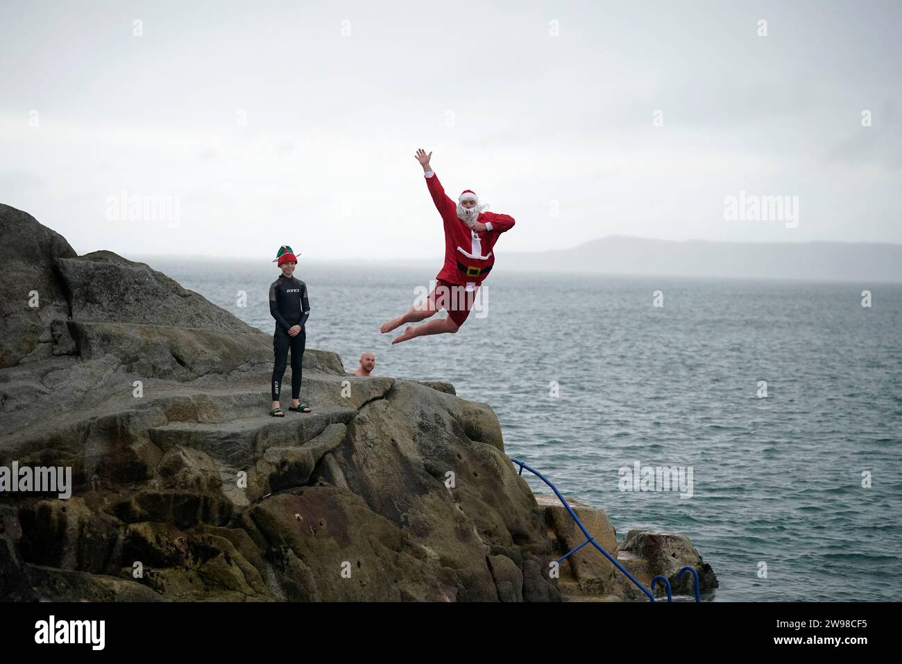 Patrick Corkery dressed as Santa and his son Matthew, 12, dressed as an ...