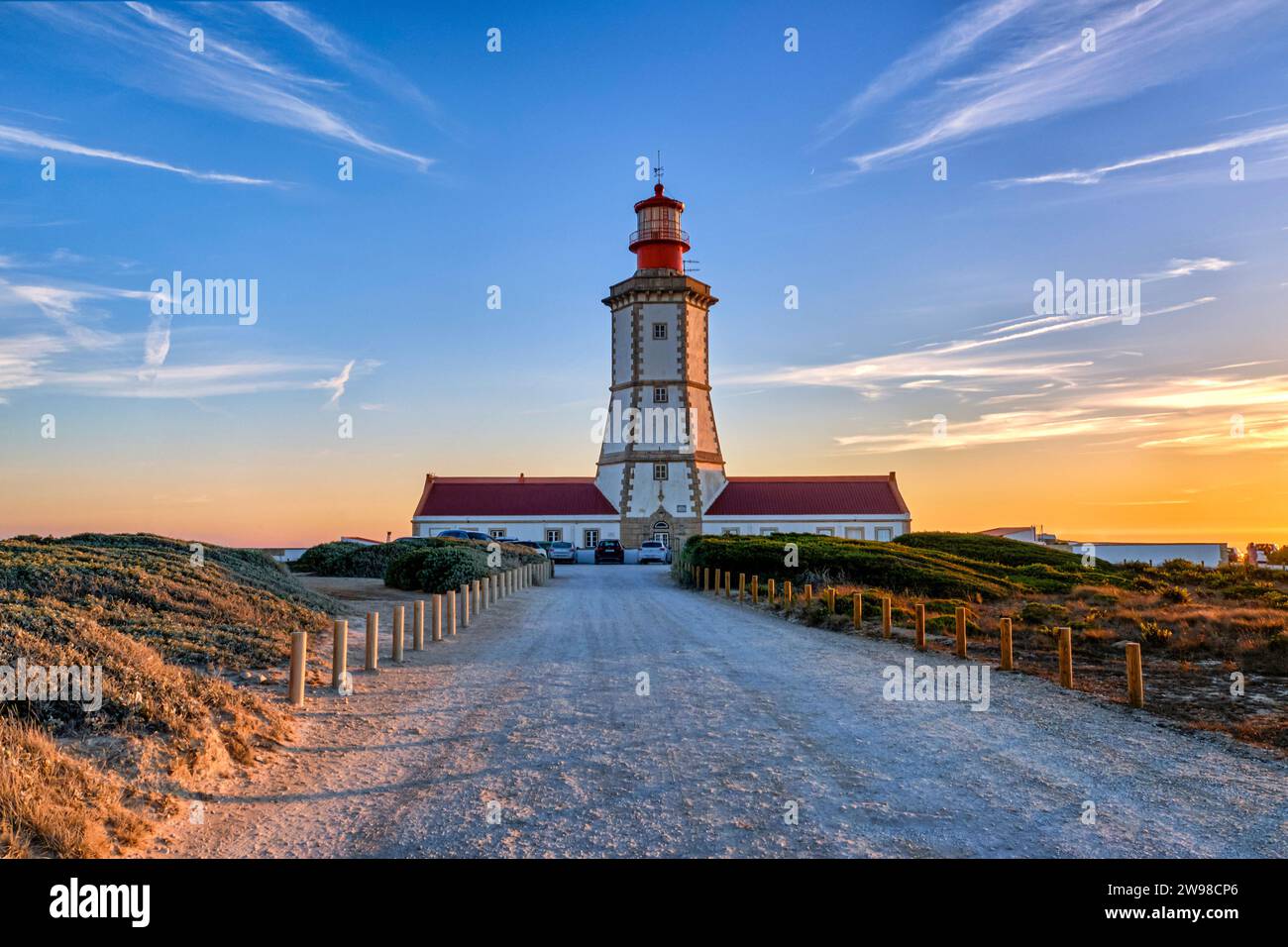 Beautiful of coastal lighthouse in warm colors of sunset, a clear path ...