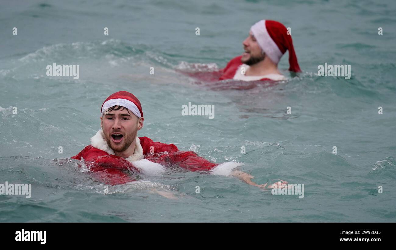Swimmers dressed as santa taking part in the annual Christmas Day swim ...