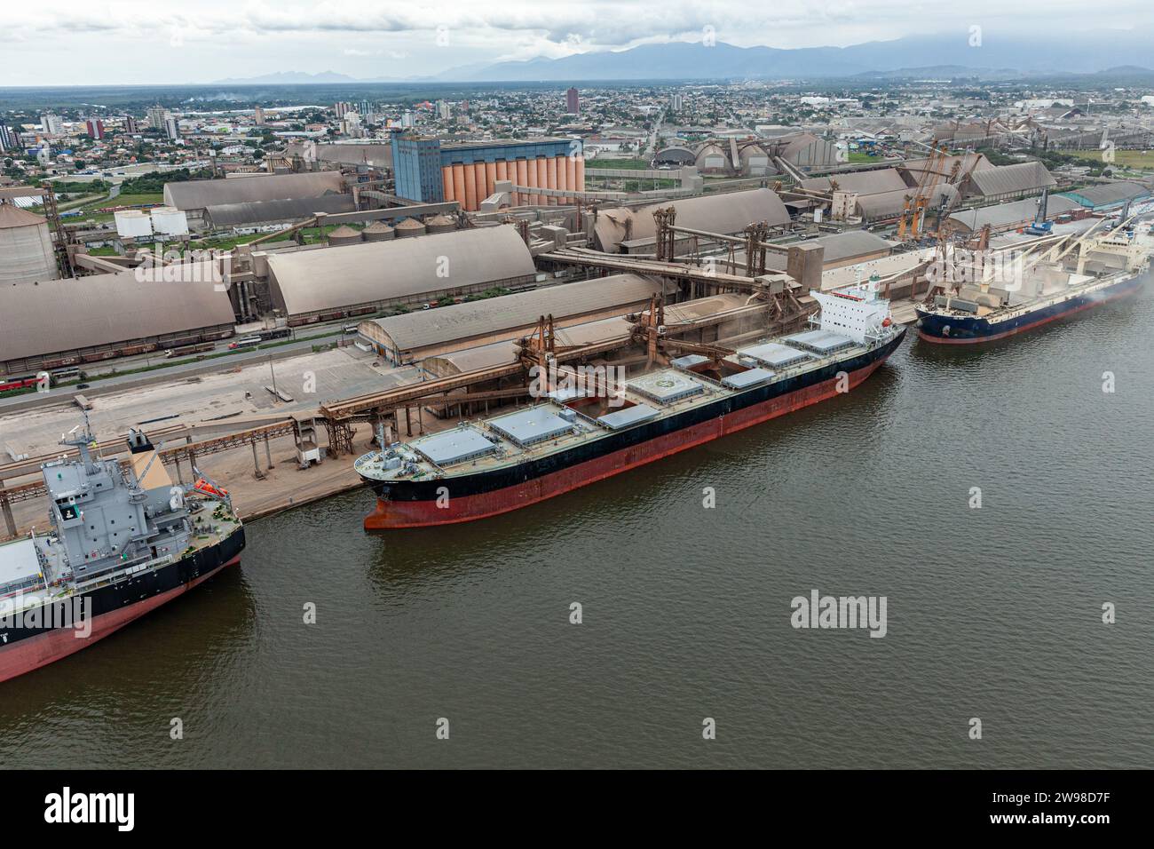 cargo ship carrying soybeans for export, in a port with cranes and ...