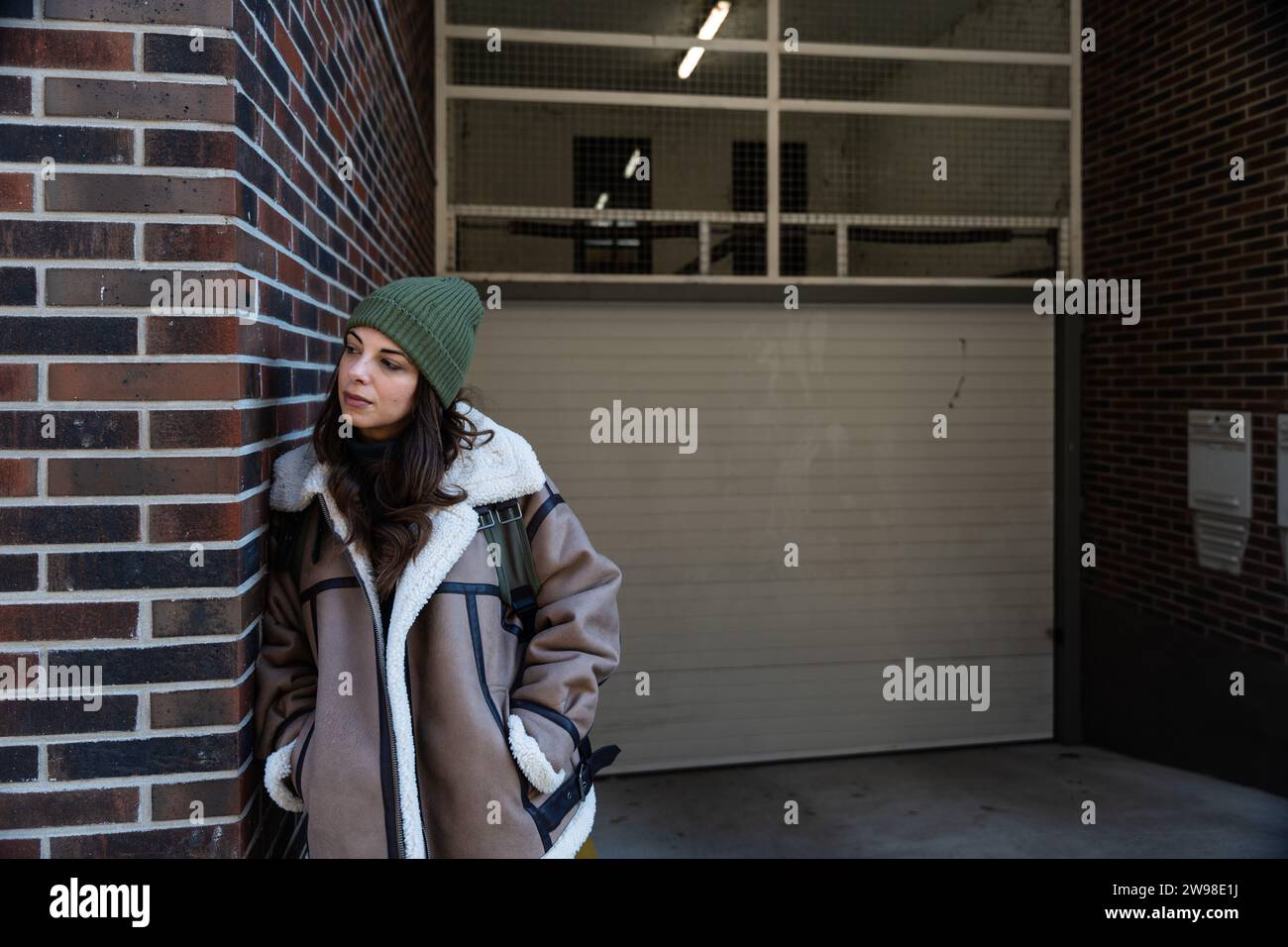 Young homeless girl or woman standing on the street. Evicted female ...