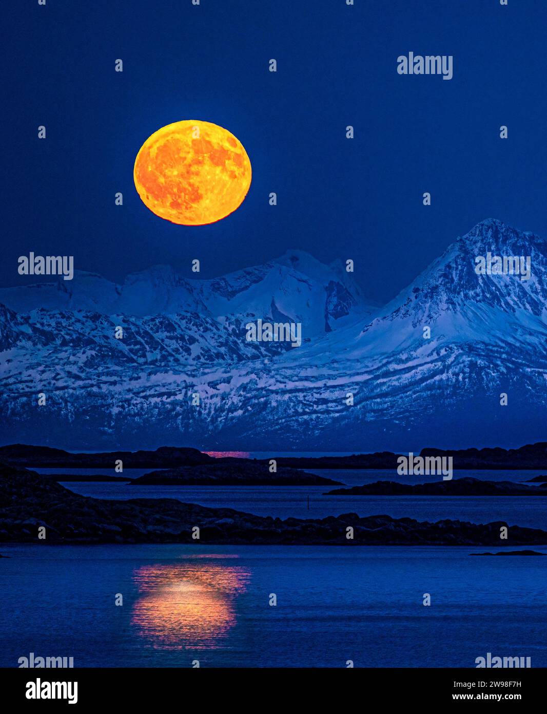 Large supermoon rising behind the majestic mountains of Lofoten ...