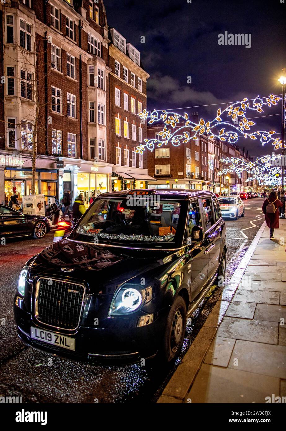 London Black Cab Electric at Christmas in Marylebone High Street UK ...