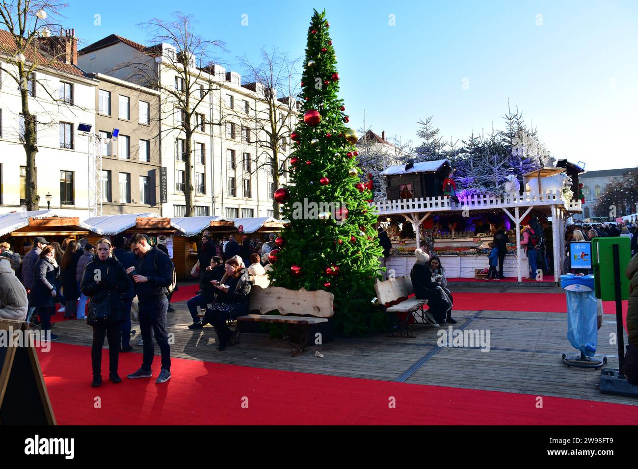 People visiting the Brussels christmas market on a sunny winter day ...