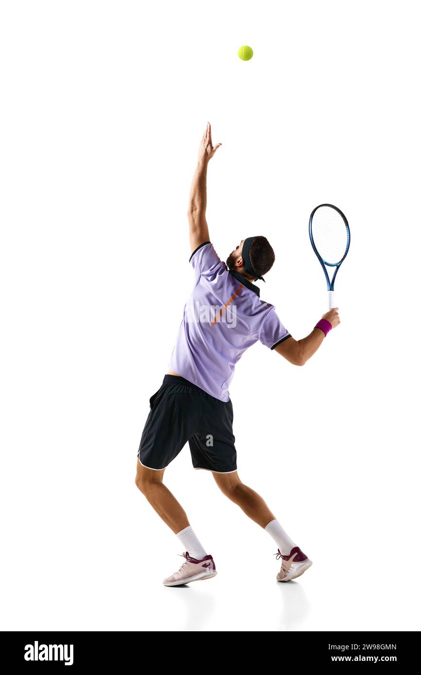 Full-length dynamic image of young man, tennis player in motion ...