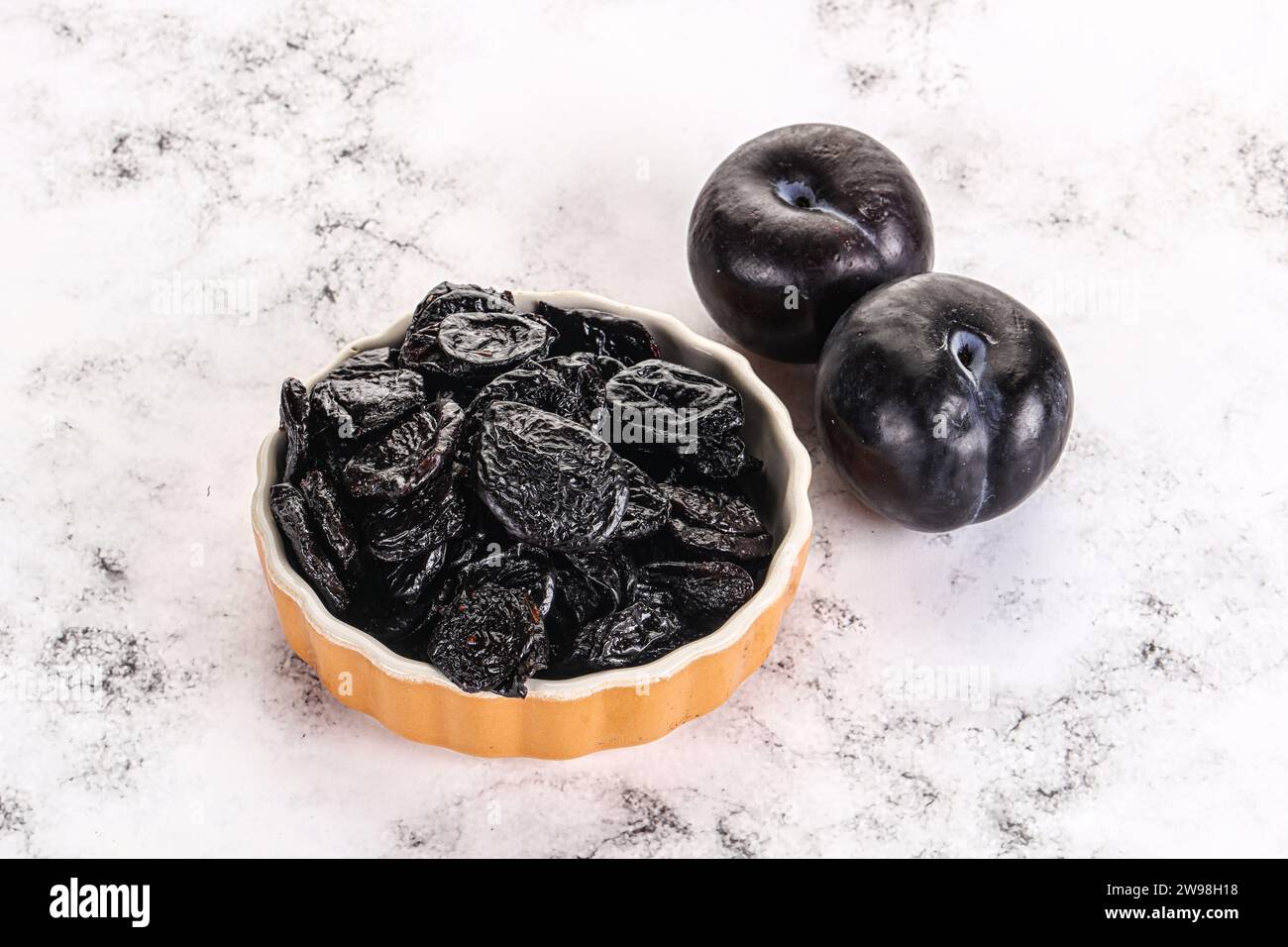 Dry sweet prunes in thw bowl Stock Photo - Alamy