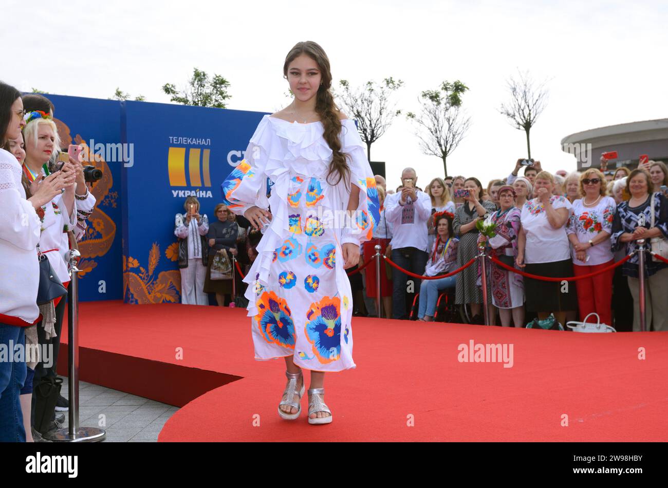Young girl in Ukrainian national embroidered dress posing in front of a ...