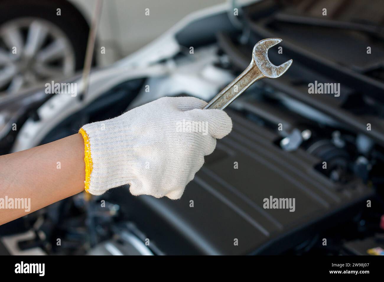 Hand with wrench repairing and checking car engine Stock Photo - Alamy