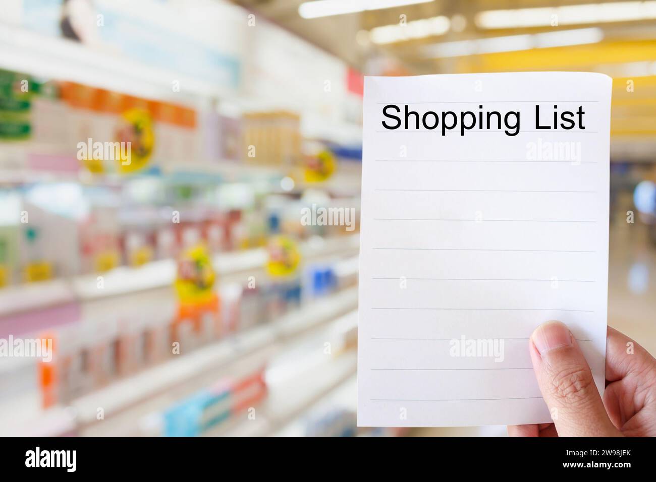 hand hold white paper over supermarket blurred background Stock Photo ...