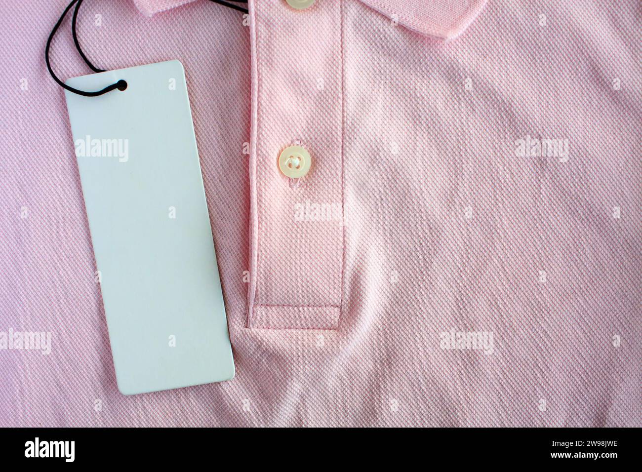 blank price tag on polo shirt Stock Photo - Alamy