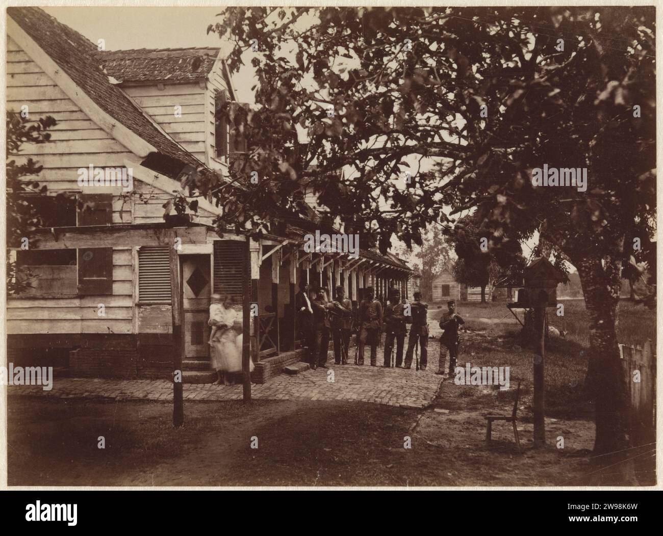 Post Sommelsdijk, 1884 photograph Seven soldiers pose for one of the homes of Fort Sommelsdijck ...