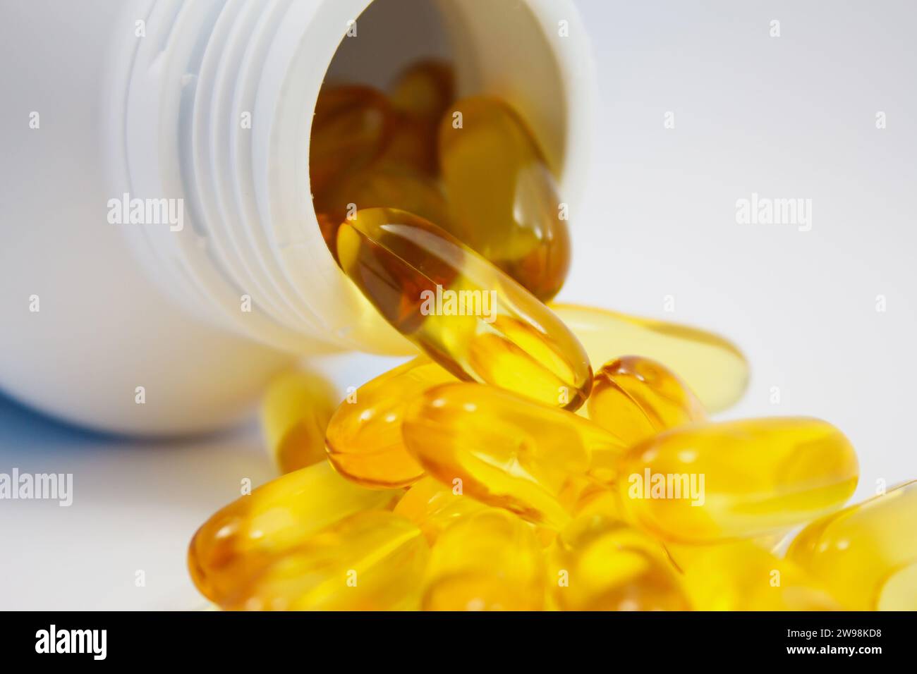 Fish oil capsules and container Stock Photo - Alamy