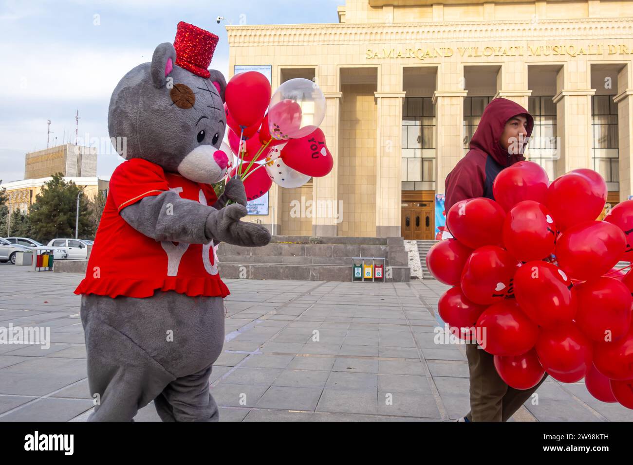 Animators in bear costume selling colorful balloons during christmas ...