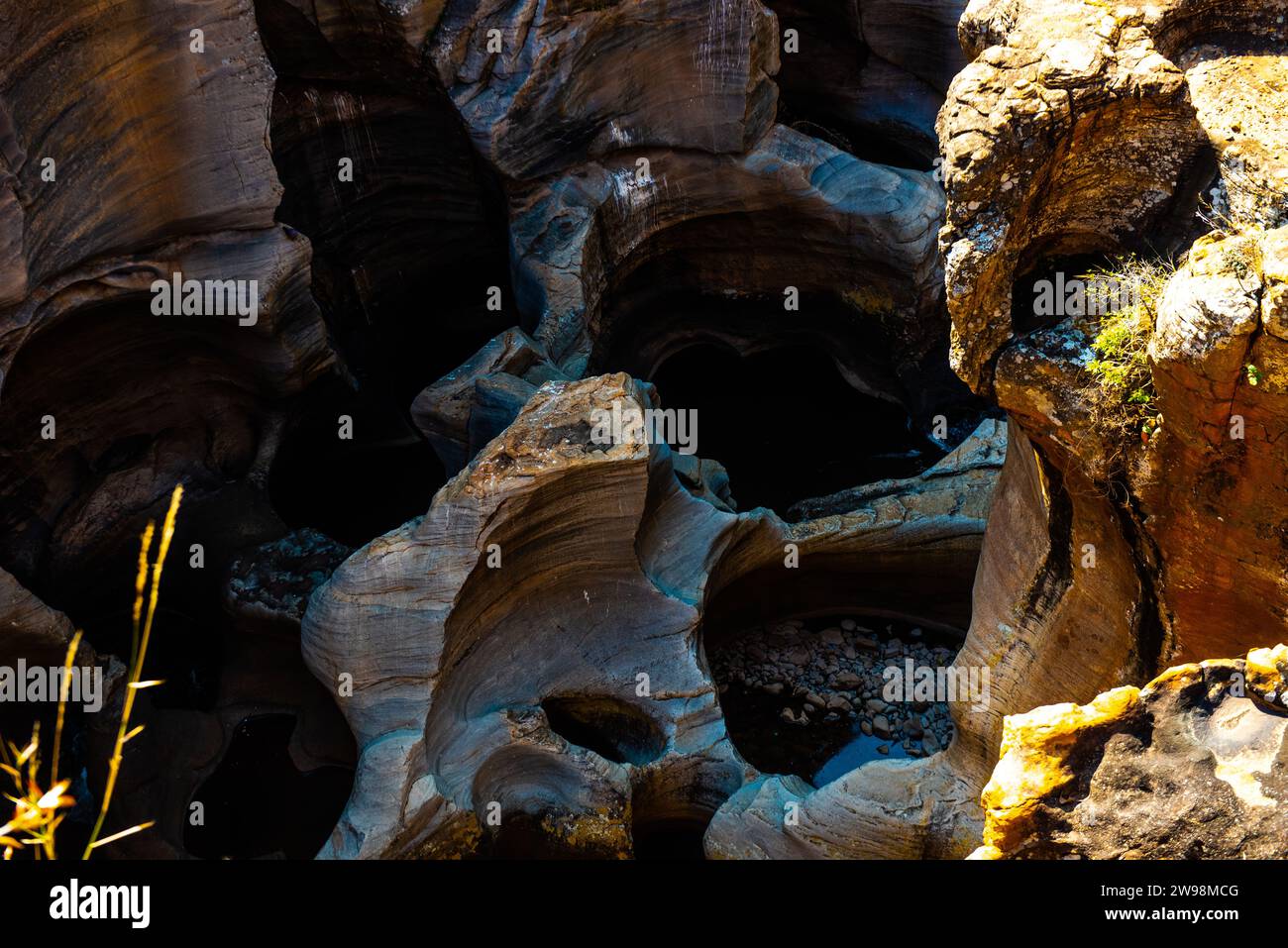 The South African potholes against the tranquil waters below Stock ...