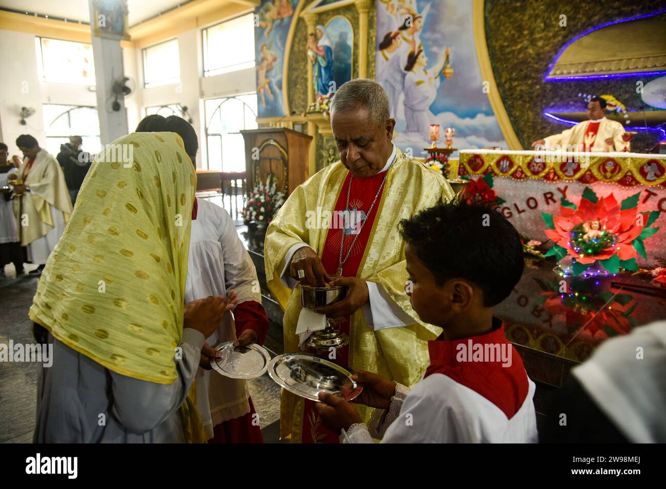 GUWAHATI,INDIA- DECEMBER 25: A Christian devotee takes holy communion ...