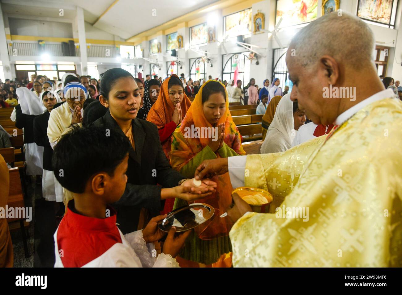 GUWAHATI,INDIA- DECEMBER 25: A Christian devotee takes holy communion ...