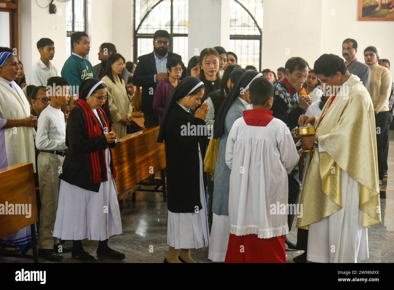 GUWAHATI,INDIA- DECEMBER 25: A Christian devotee takes holy communion ...