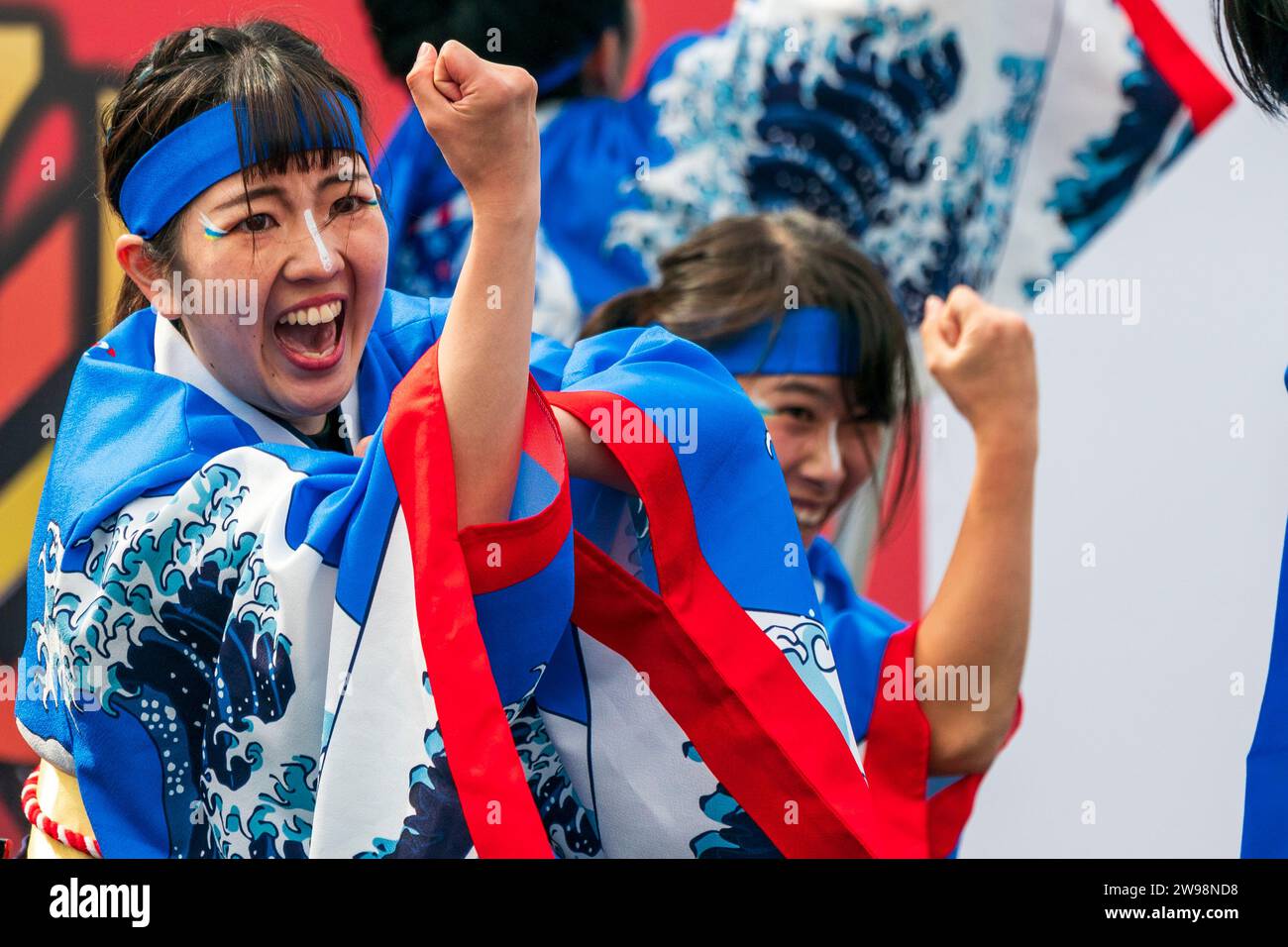 Close up, young Japanese man yosakoi dancer dancing with arm raised ...