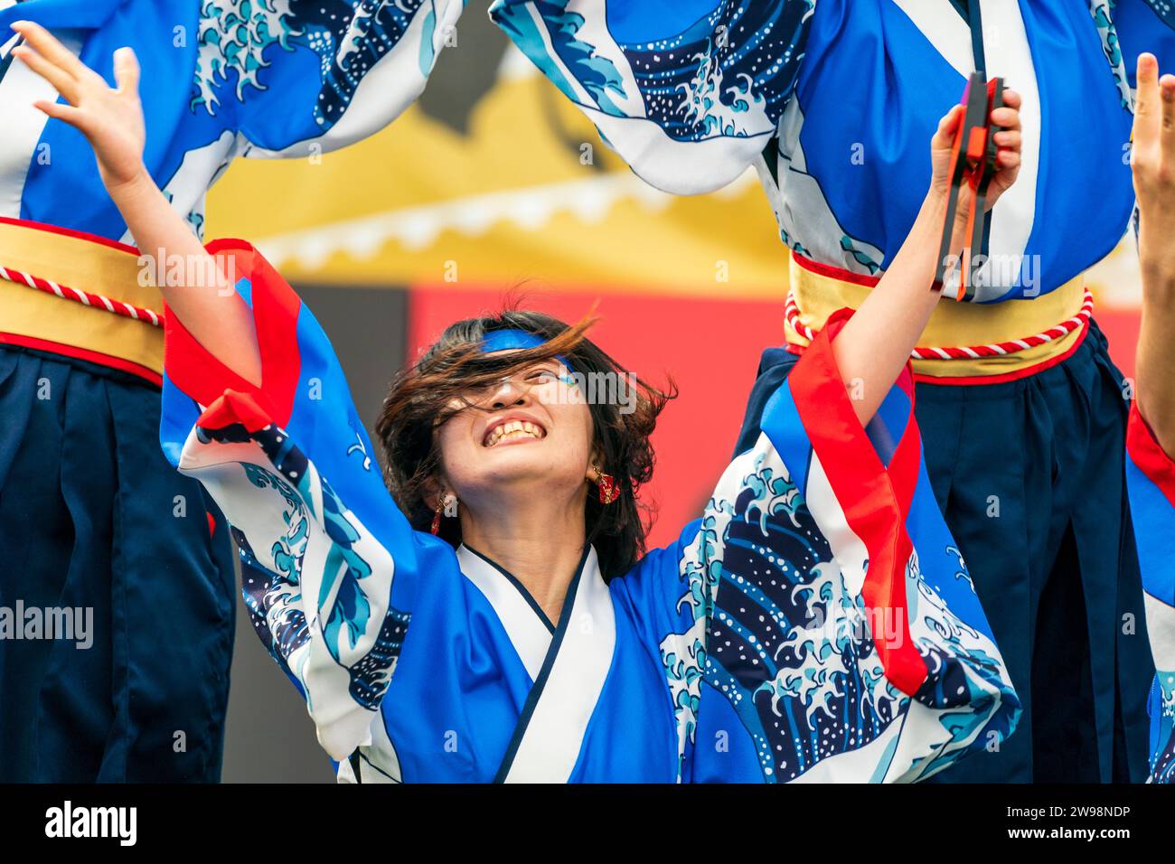 Close up, young Japanese woman yosakoi dancer with both arms raised ...