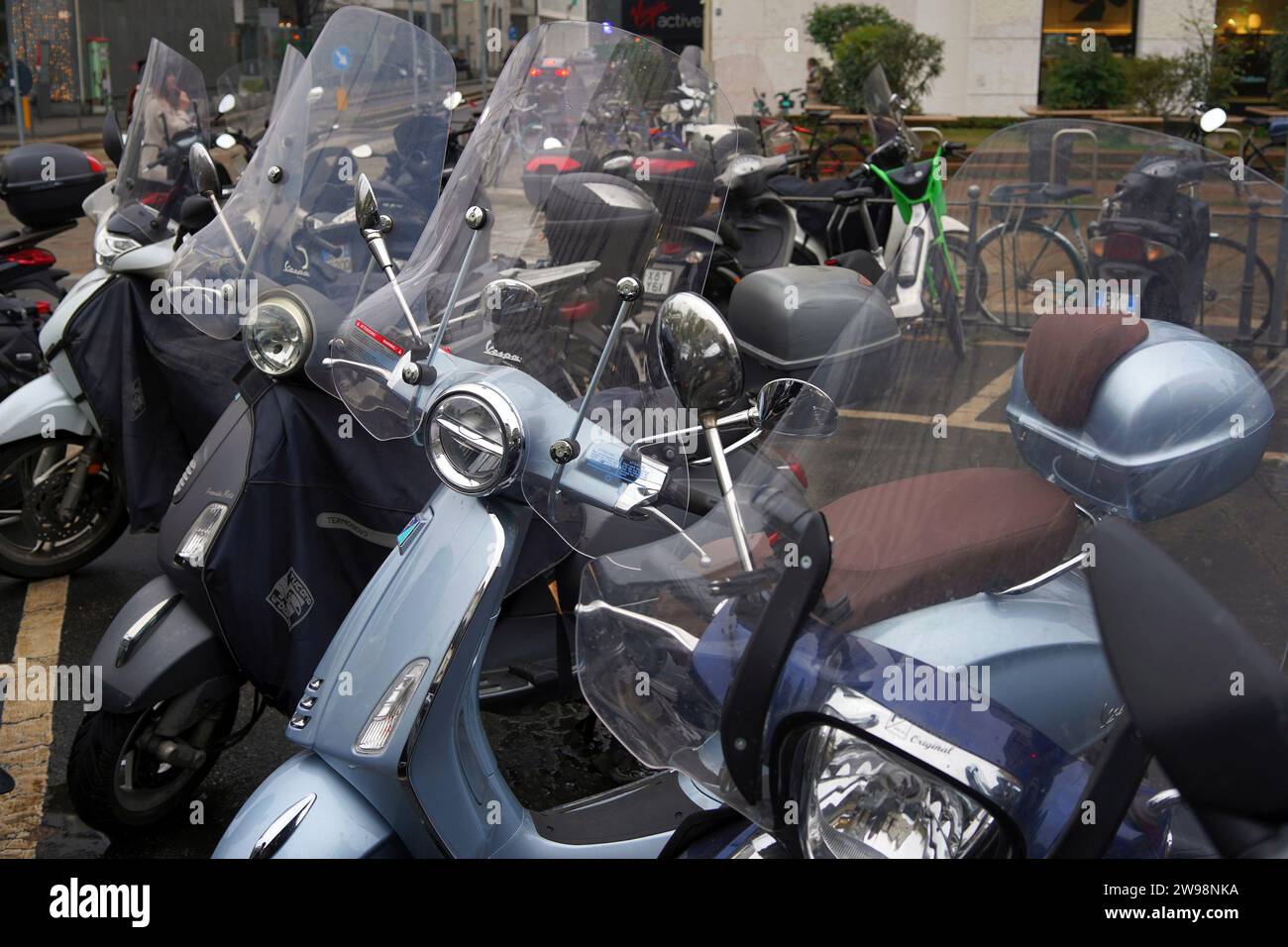 Vespa Mopeds parked in a row in Milan, Italy Stock Photo - Alamy