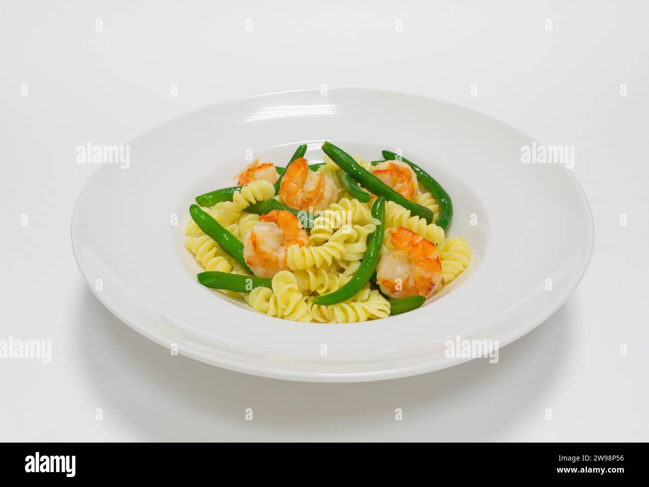 Gourmet pasta with tiger prawns and green beans. Top view. White ...