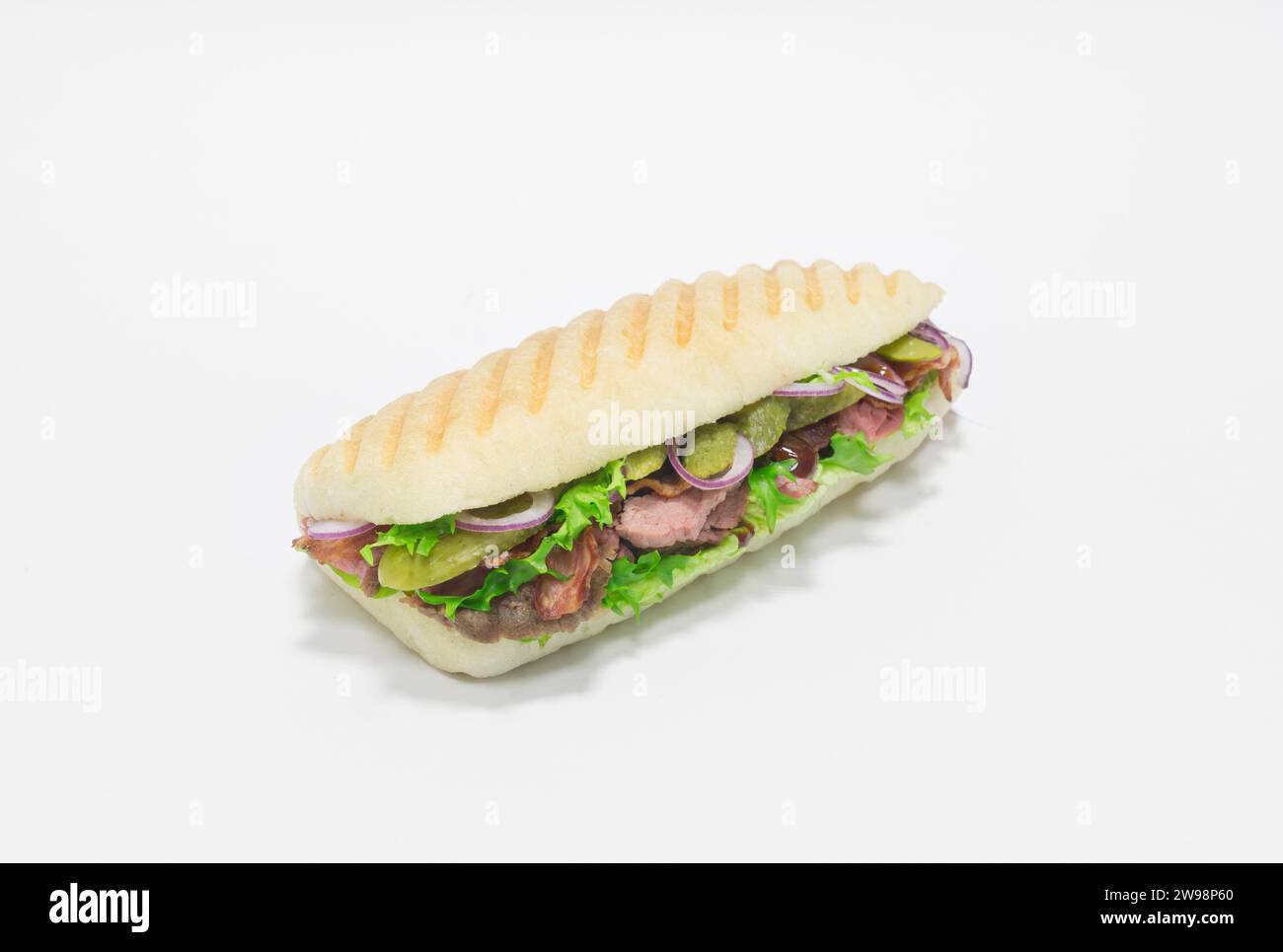 Gourmet panini with ham, pickled cucumbers and onions. Top view. White ...