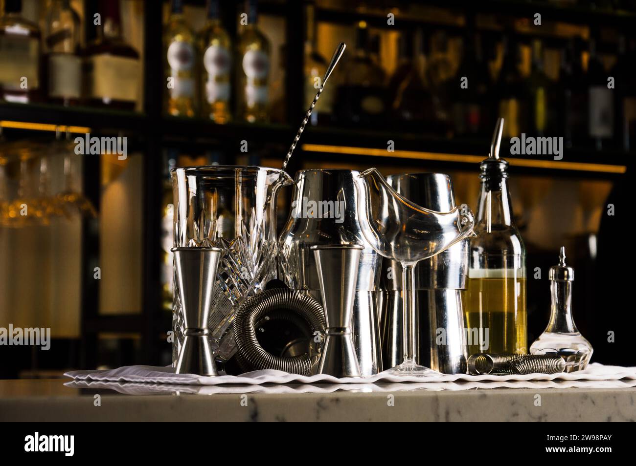 Set of bar accessories for making cocktails, located on the bar, behind ...