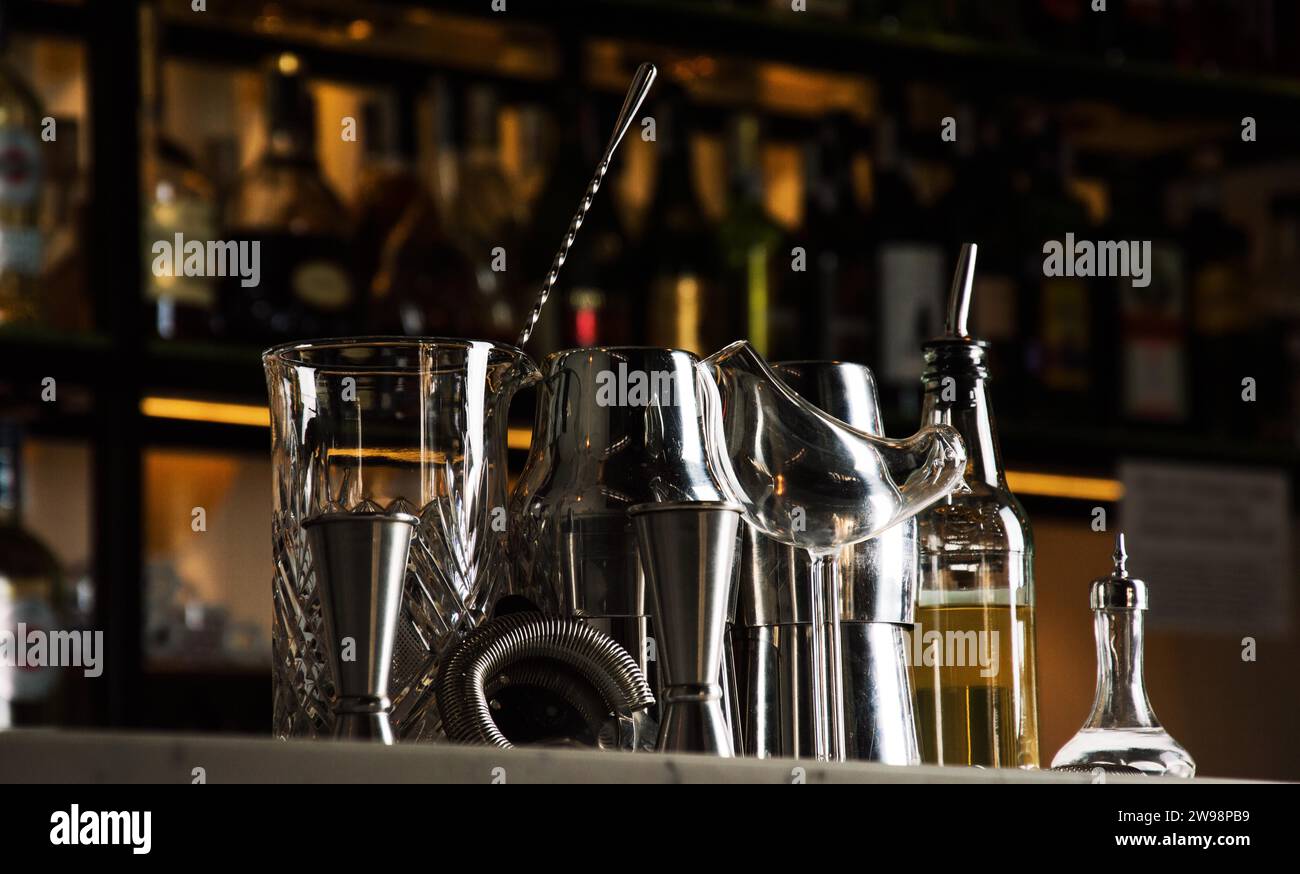 Set of bar accessories for making cocktails, located on the bar, behind ...