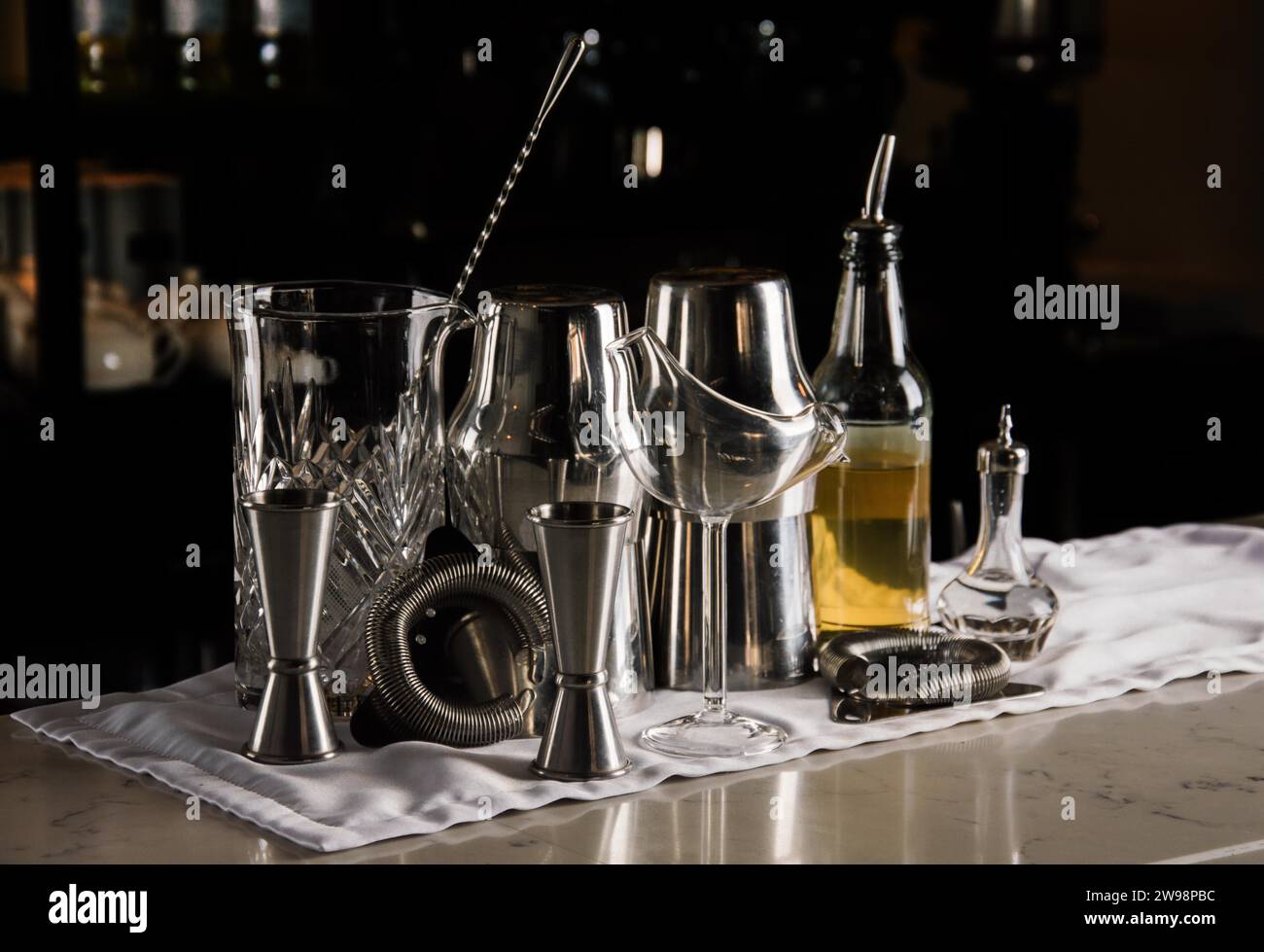 Set of bar accessories for making cocktails, located on the bar, behind ...