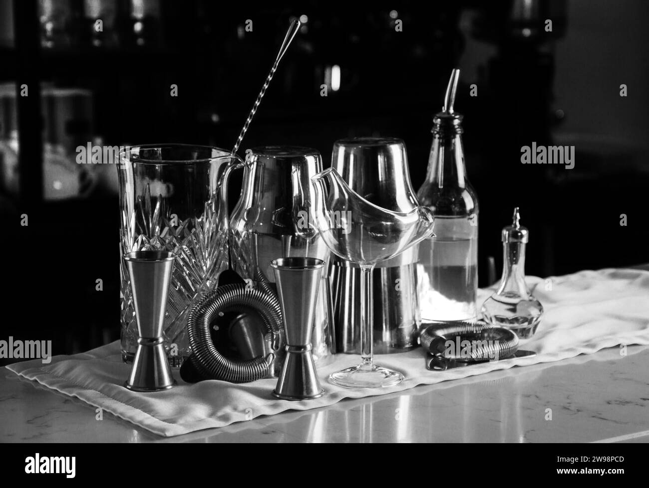 Set of bar accessories for making cocktails, located on the bar, behind ...