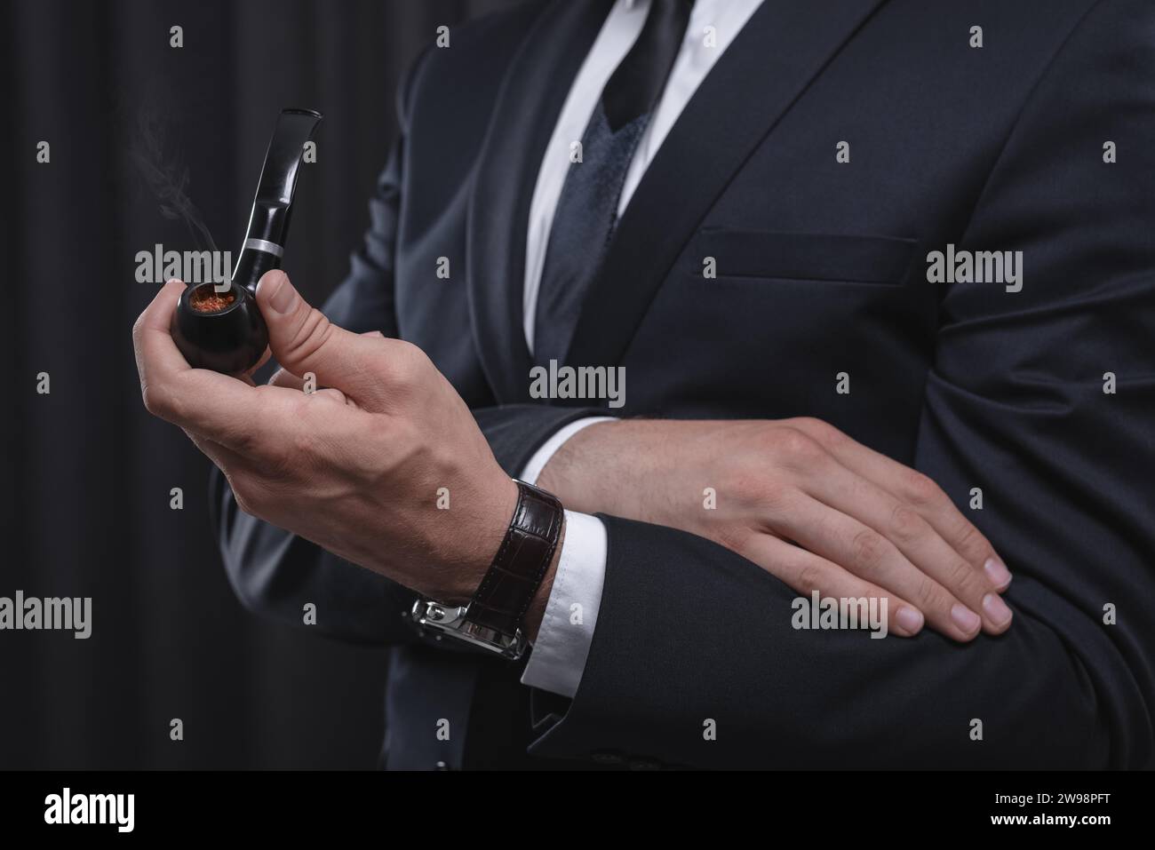 Image of male hands holding a smoking pipe. Tobacco smoking concept ...