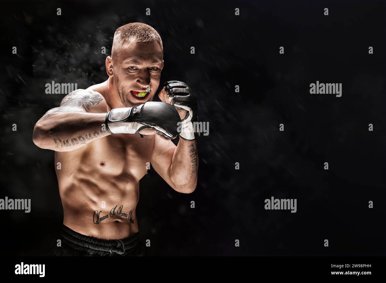 Mixed martial artist posing on a black background. Concept of mma, thai ...