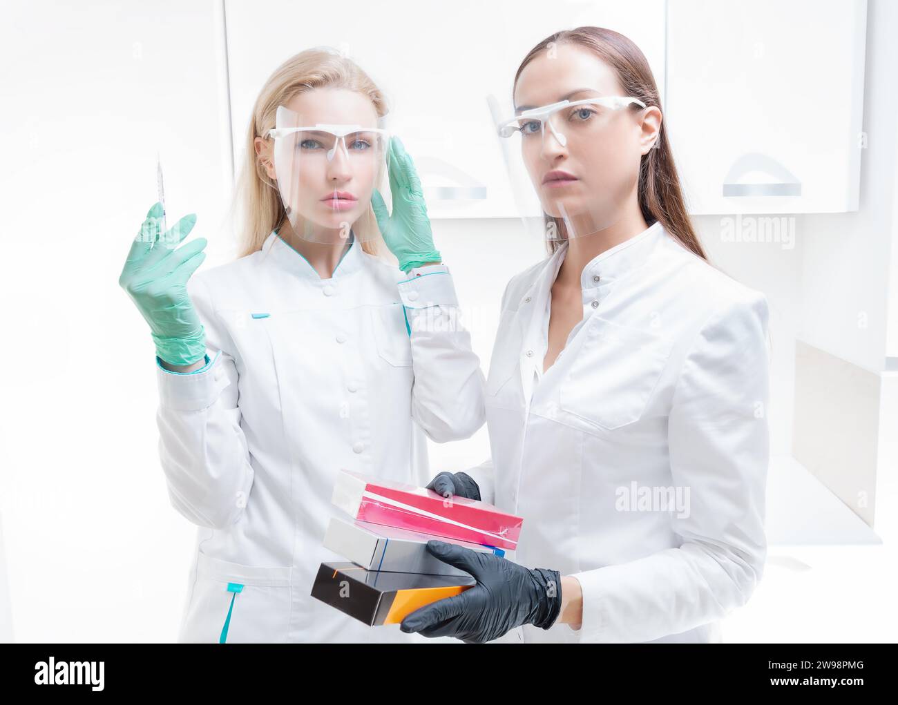 Two beauticians pose in a medical office with cosmetic preparations and ...