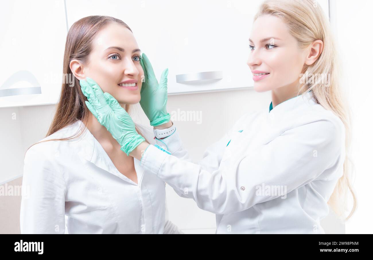 Beautiful girl at a consultation in the salon with a plastic surgeon ...
