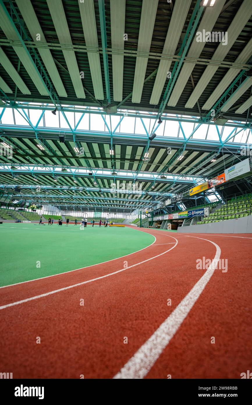Interior view of a sports hall with running track and stands. Glass ...