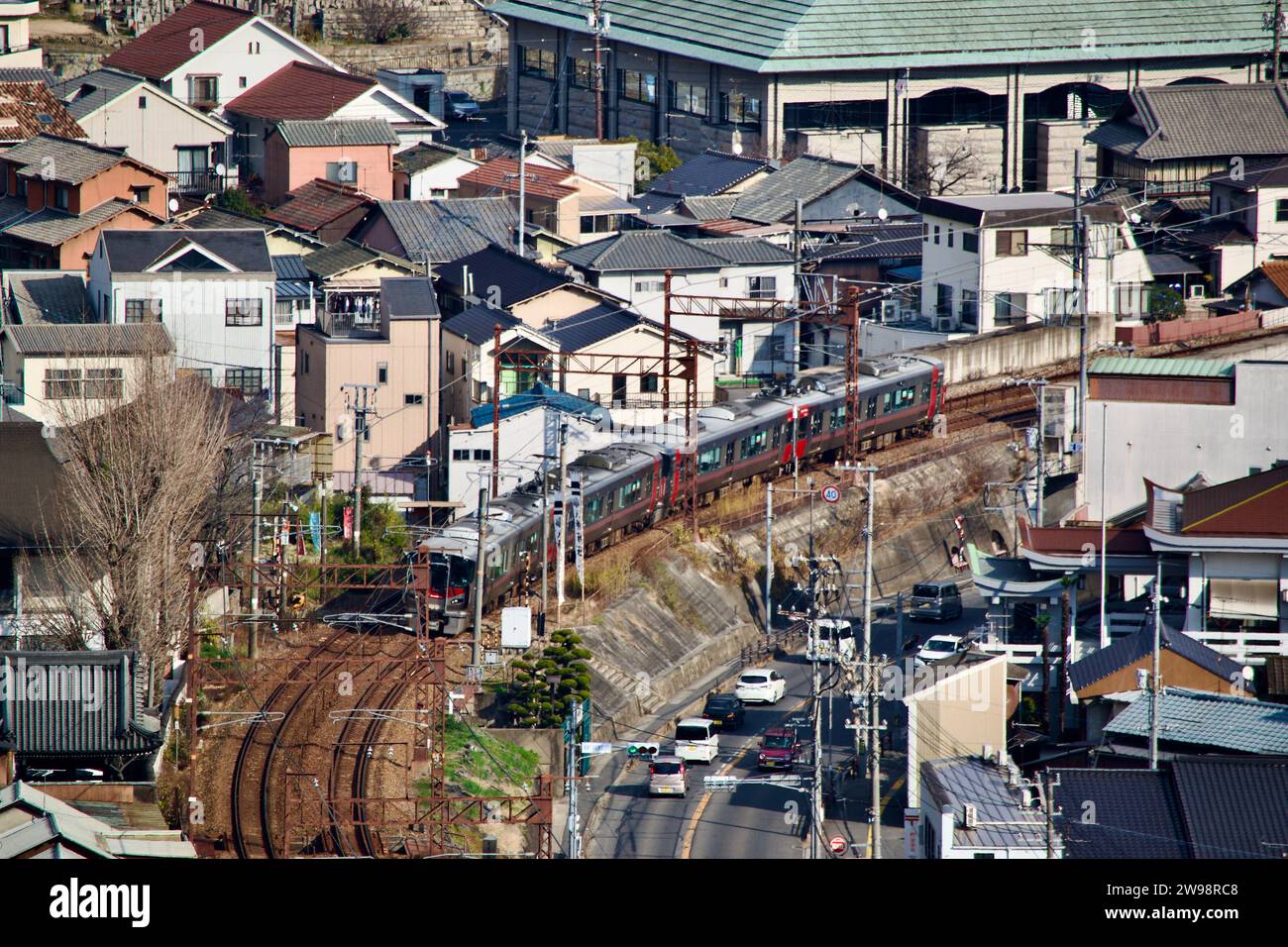 Japanese red arrow train passing through Onomichi city Stock Photo - Alamy