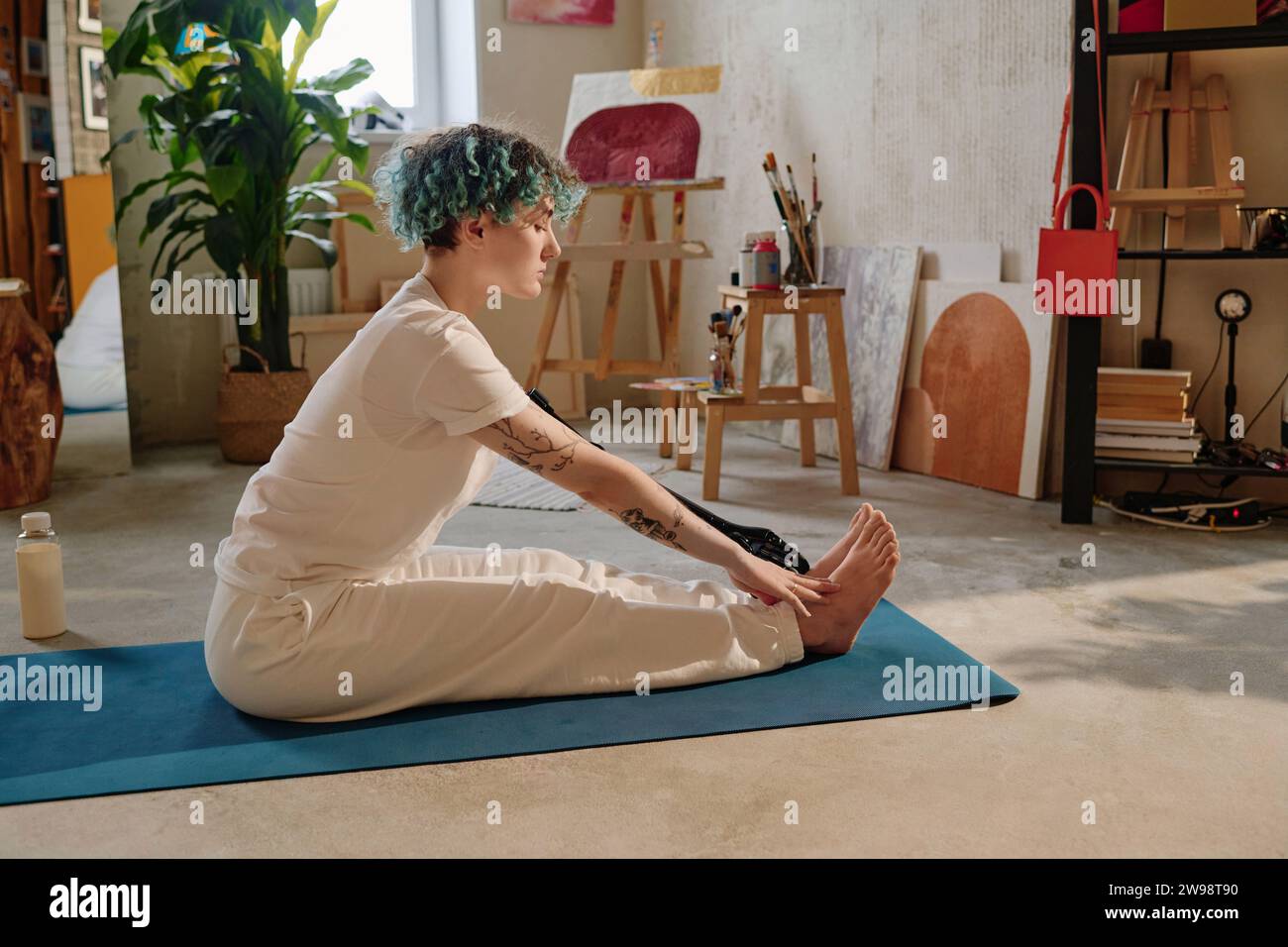 Teenage Amputee Girl Doing Seated Leg Stretch Hamstrings Mobility