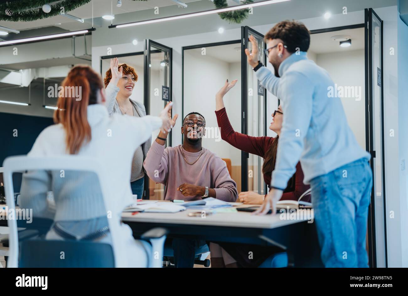 Multicultural group of businesspeople celebrating successful work ...