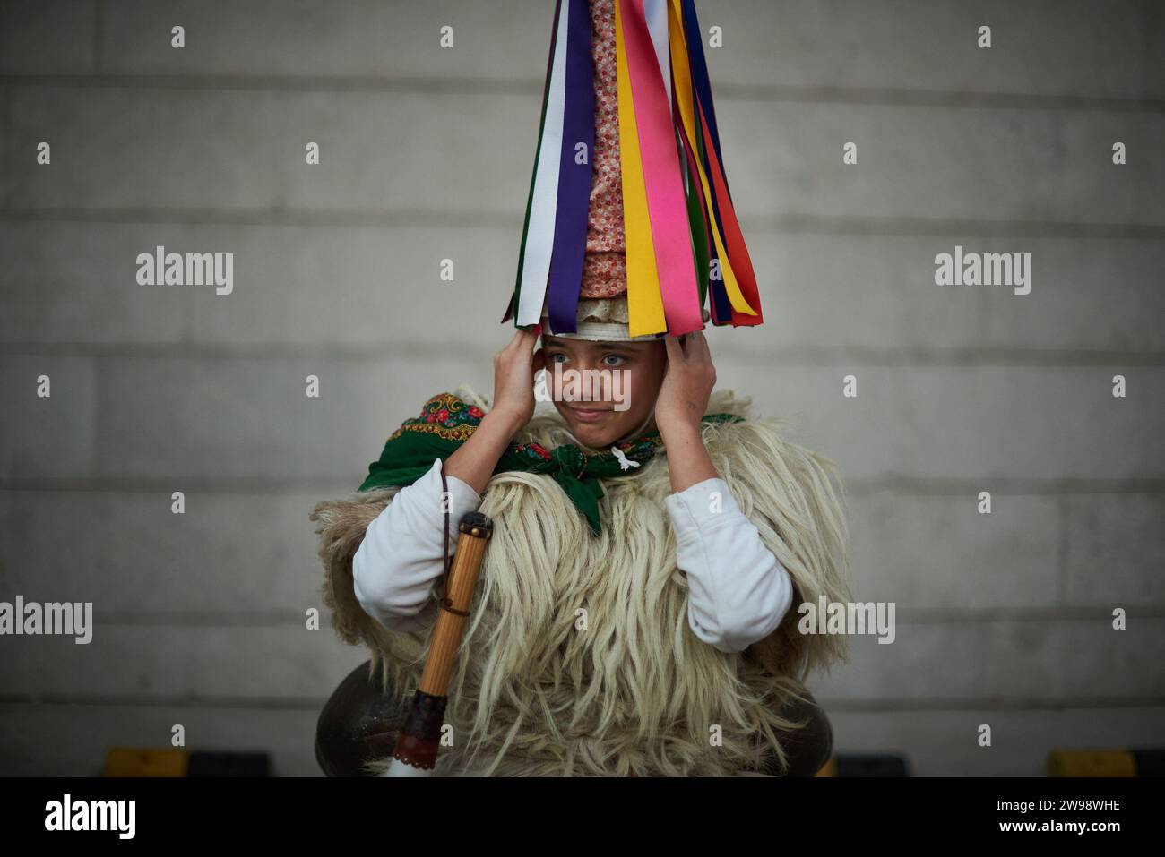 Villava, Spain. 24th Dec, 2023. A young joaldunak puts on a typical hat ...