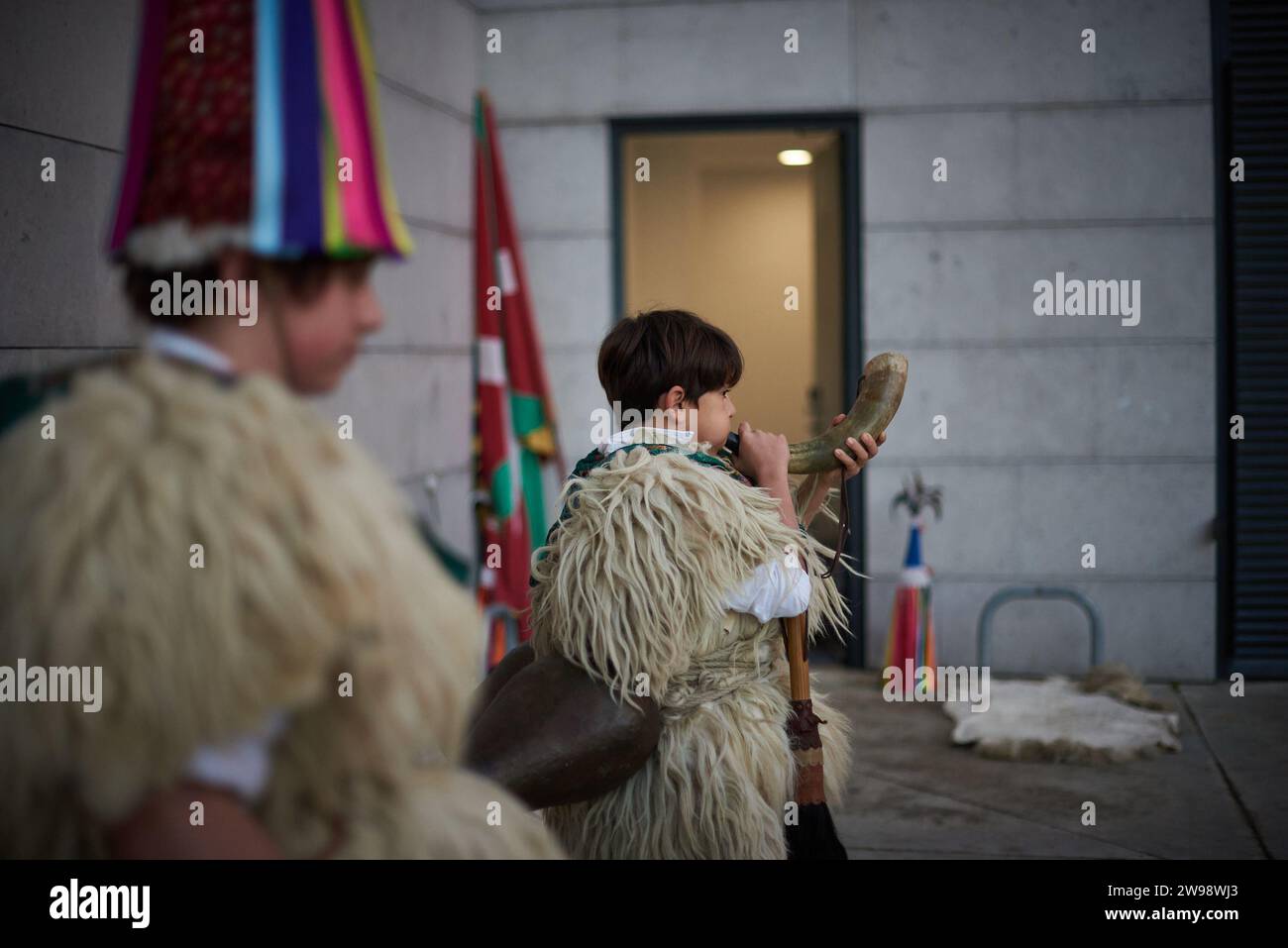 Villava, Spain. 24th Dec, 2023. A young joaldunak blows a horn, for the ...